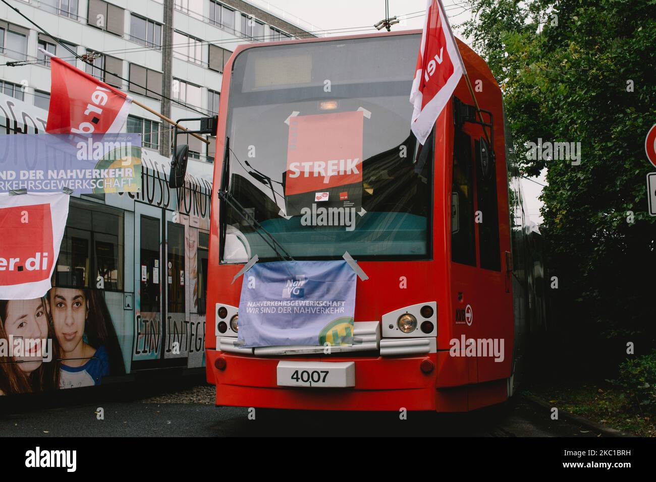 the trams are seen with striker signs and verdi union flag next to the ...