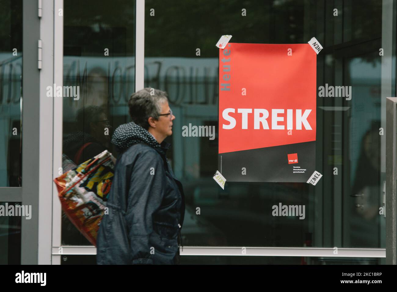 a woman walks pass the strike sign at the local public transportation ...
