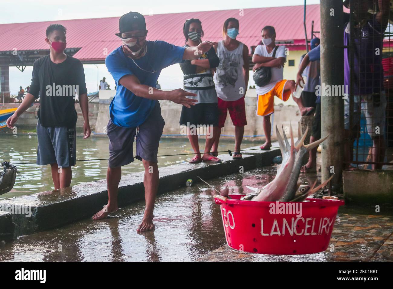 A group of fish porter in Binangonan, Rizal are unloading the basin ...