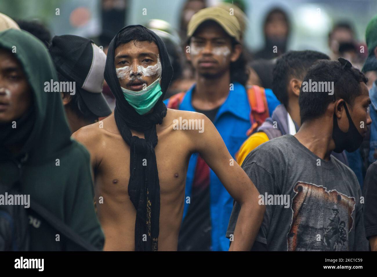 A student takes off his clothes while protesting against the Omnibus ...
