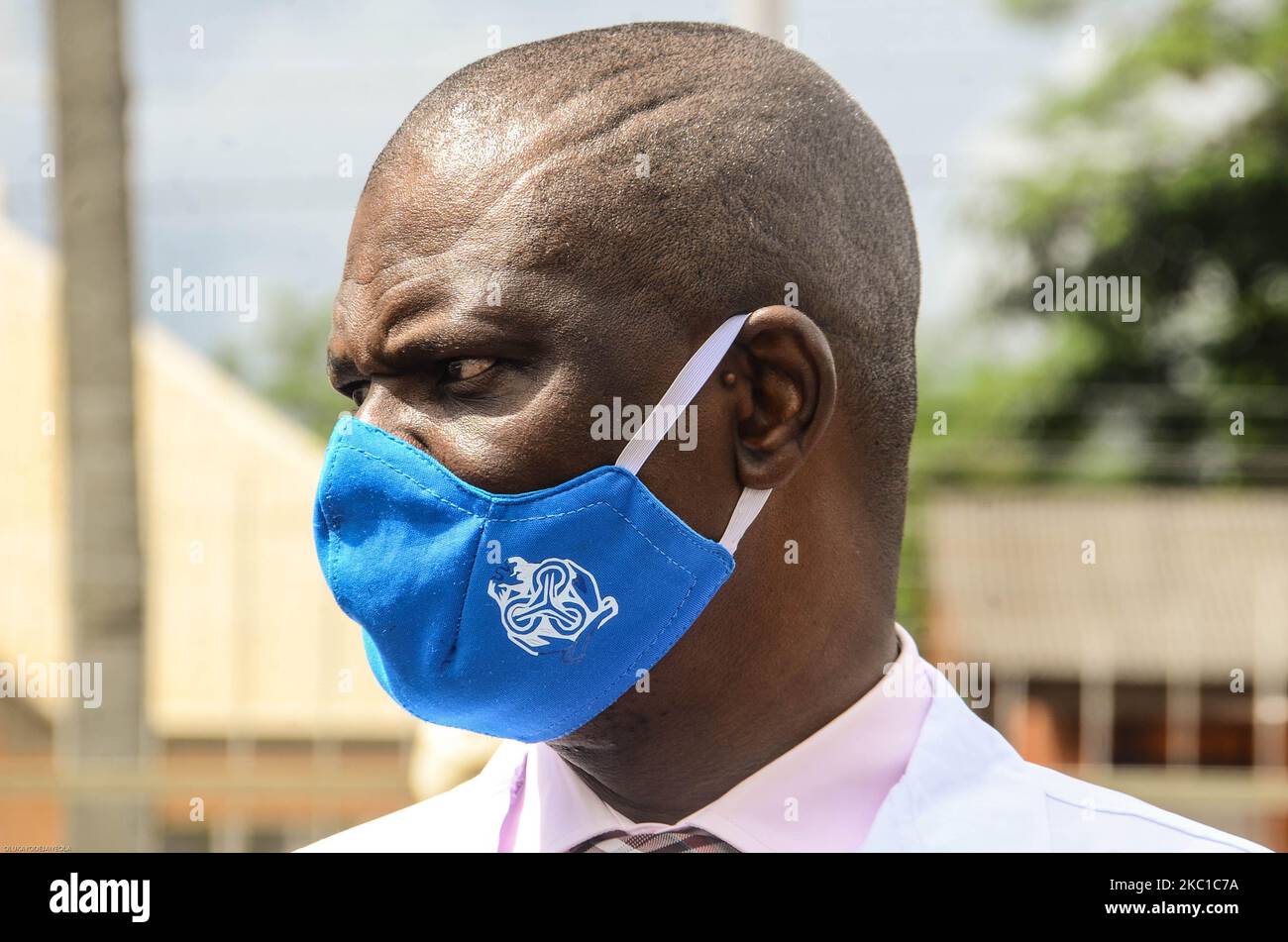 Official of Central Bank of Nigeria wearing a nose mask looks on during ...