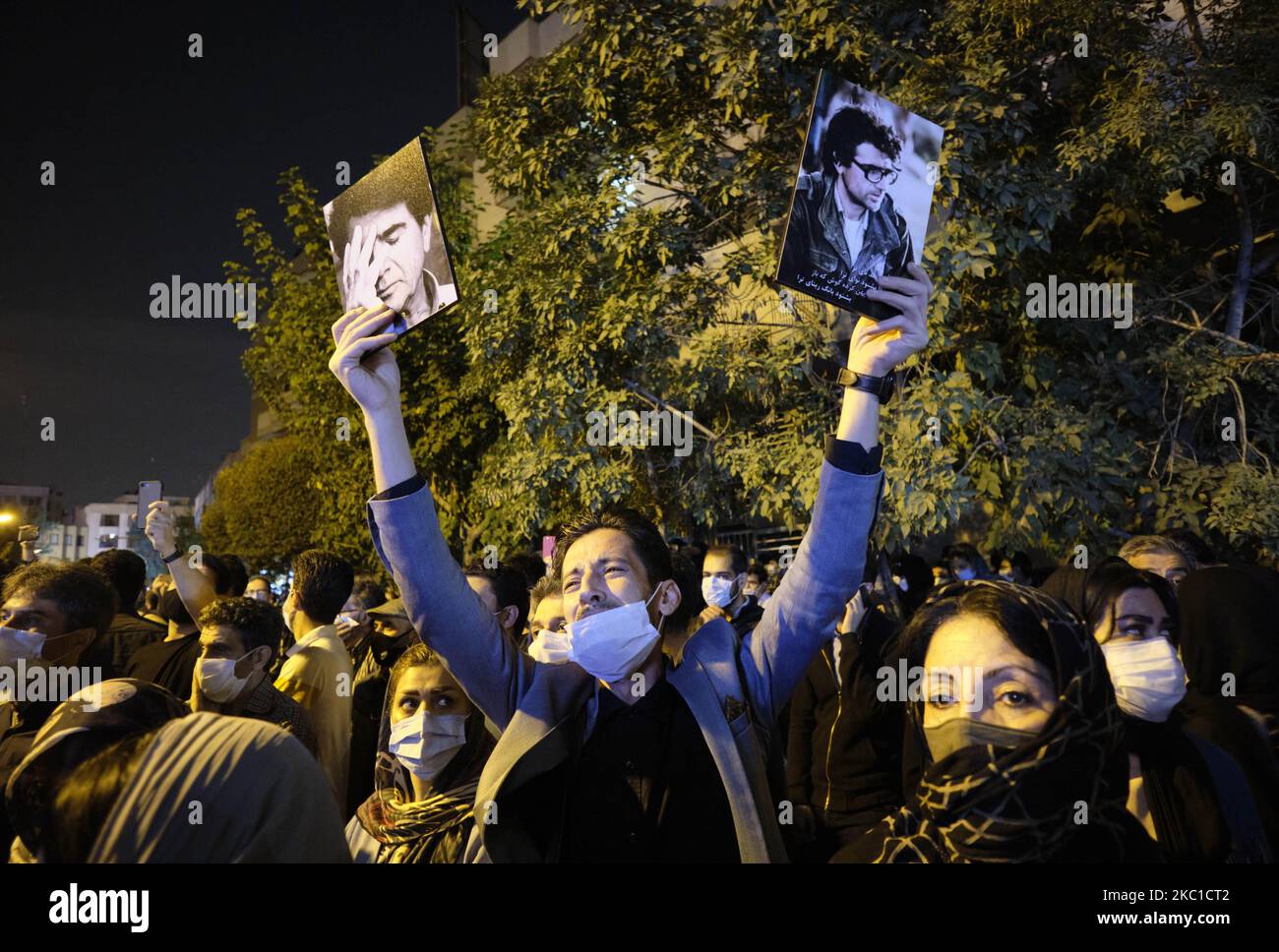 An Iranian man holds-up portraits of the Iranian iconic vocalist master ...