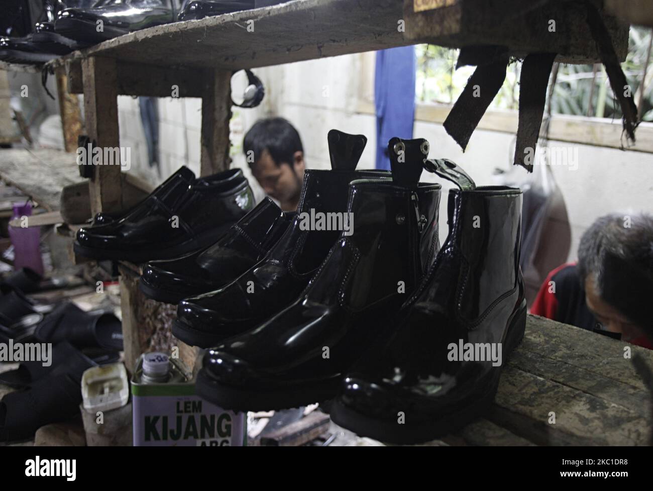 An employee works on shoes at a home Belinda shoes factory in Ciomas ...