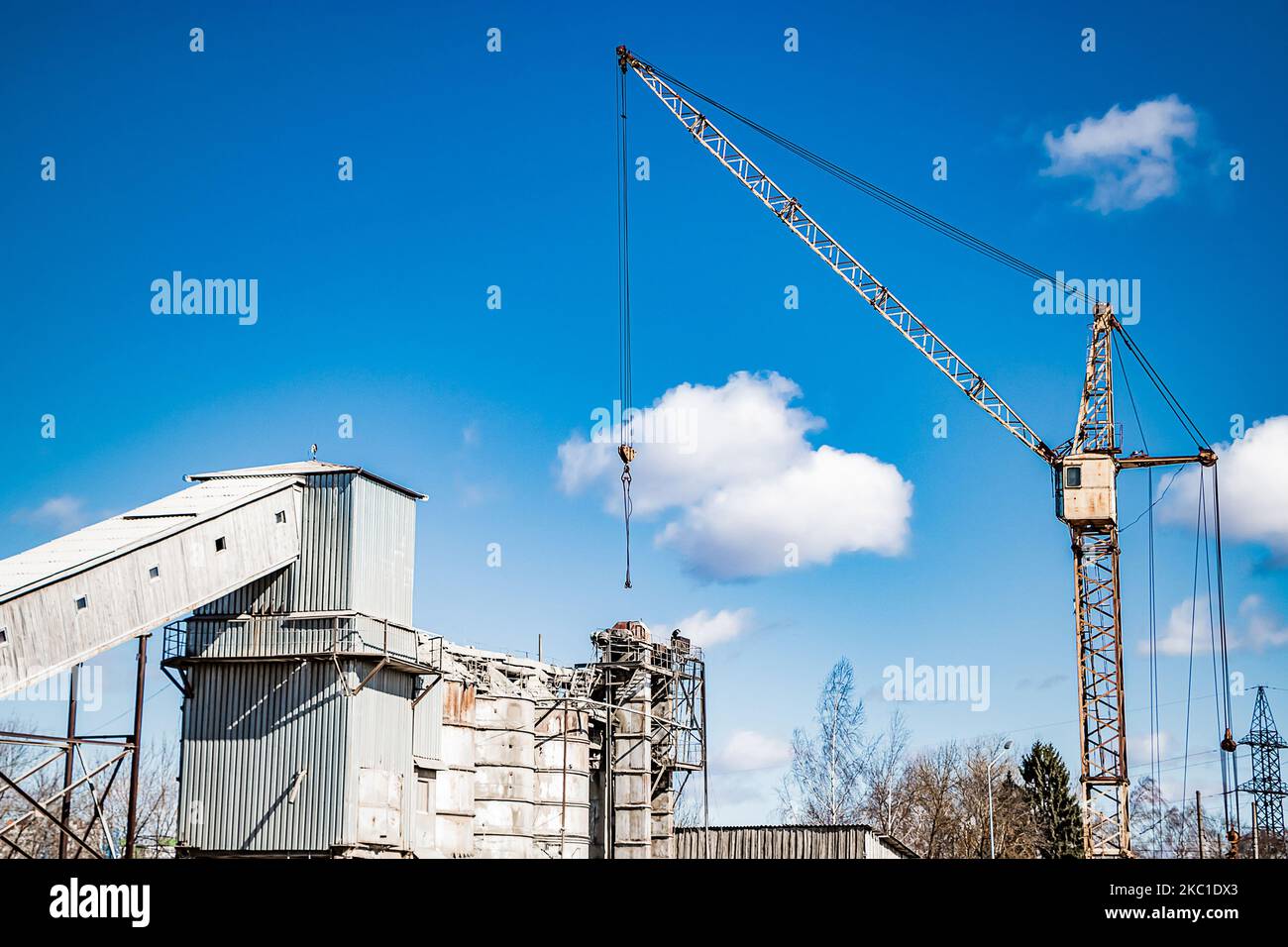 High rusty construction crane on abandoned building site. Tower crane ...