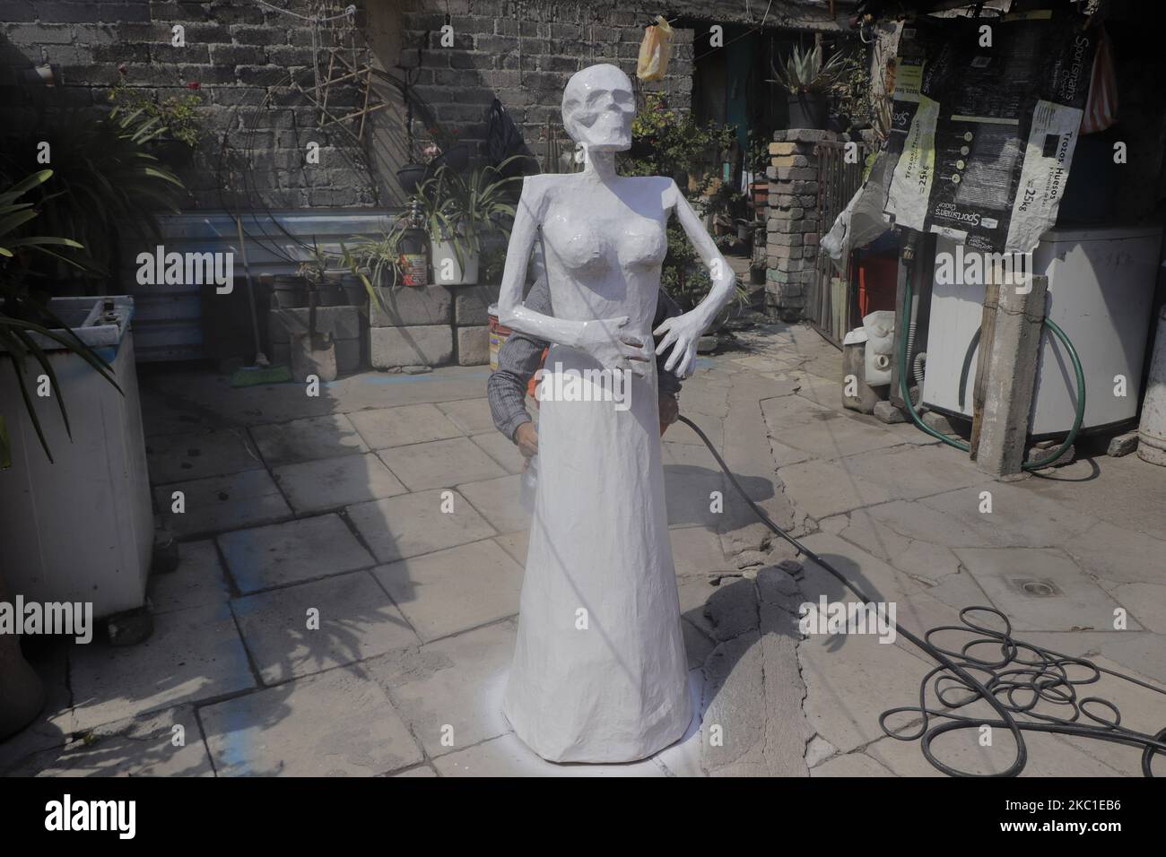 The mold of a catrina was painted white with an airbrush, based on ...