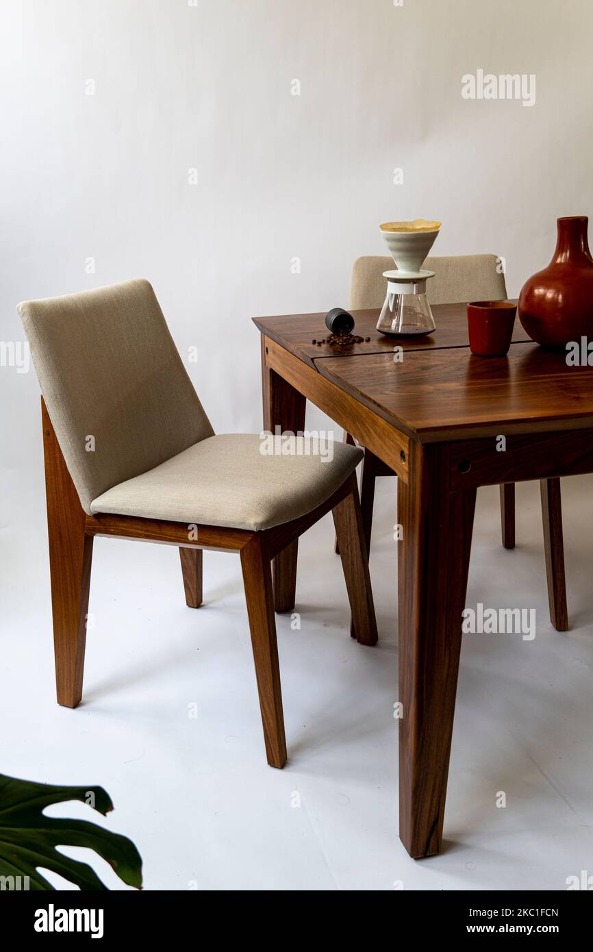 designer wood dining table, minimalist and simple objects on the table ...