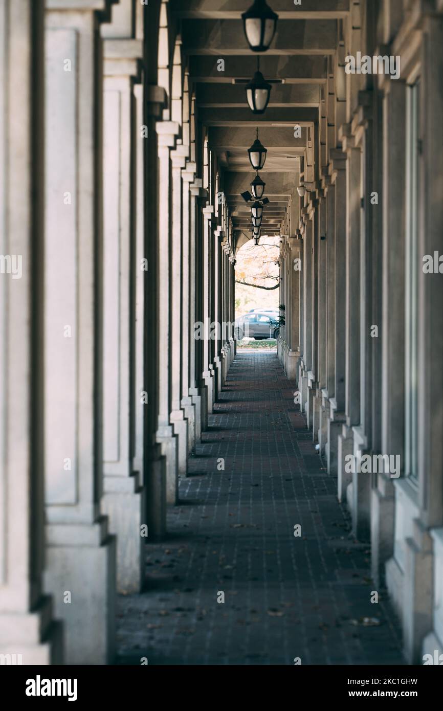 A vertical shot of the inside of a building with a narrow walkway ...