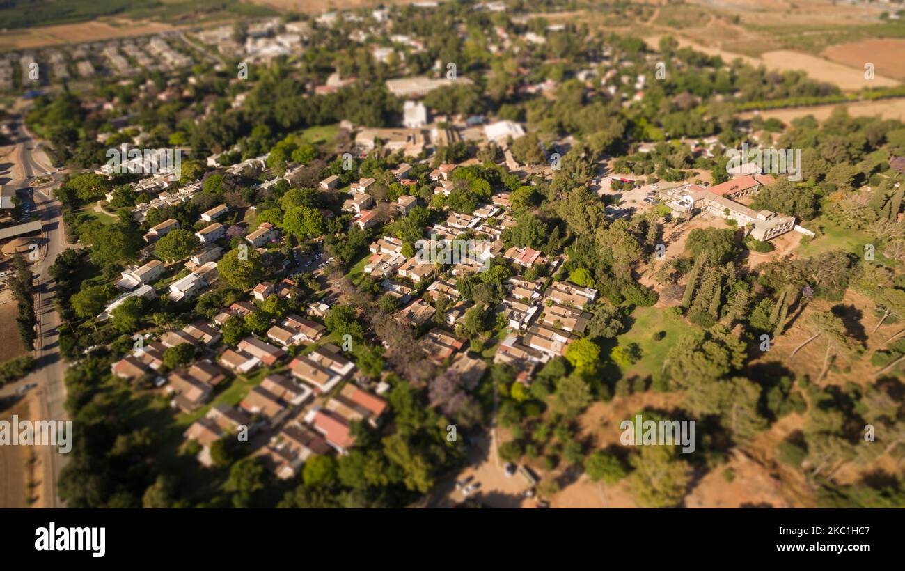 aerial view of red houses rooftops with green grass and trees in the ...