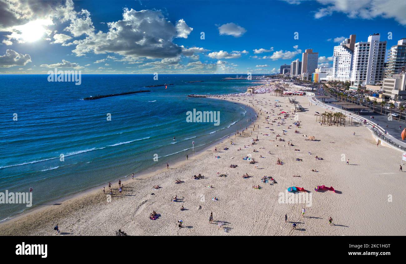 Aerial view of people bathing in the sun, swimming and playing games on ...
