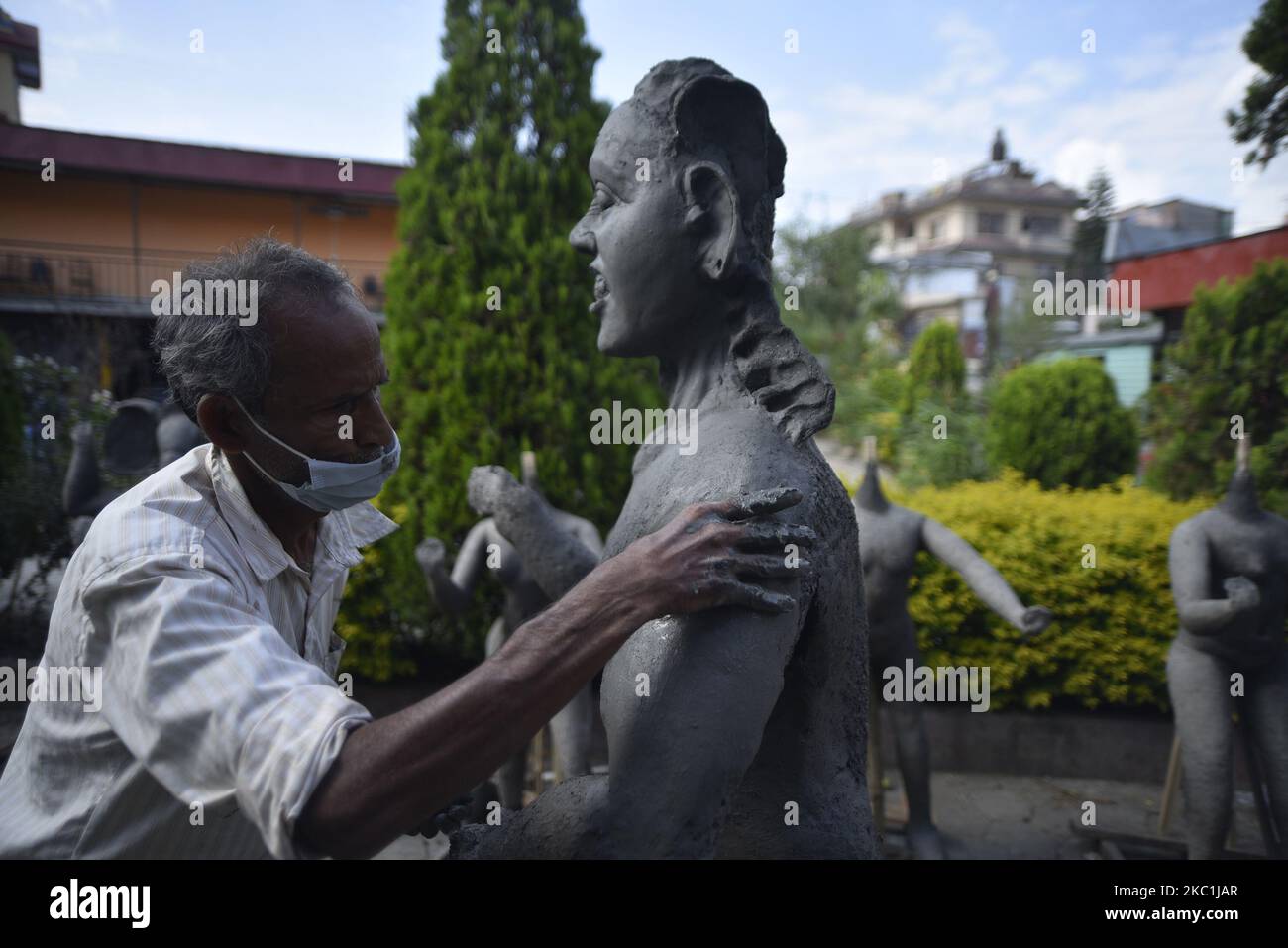 An indian artist making a clay statue of Hindu demon Mahishasura at ...