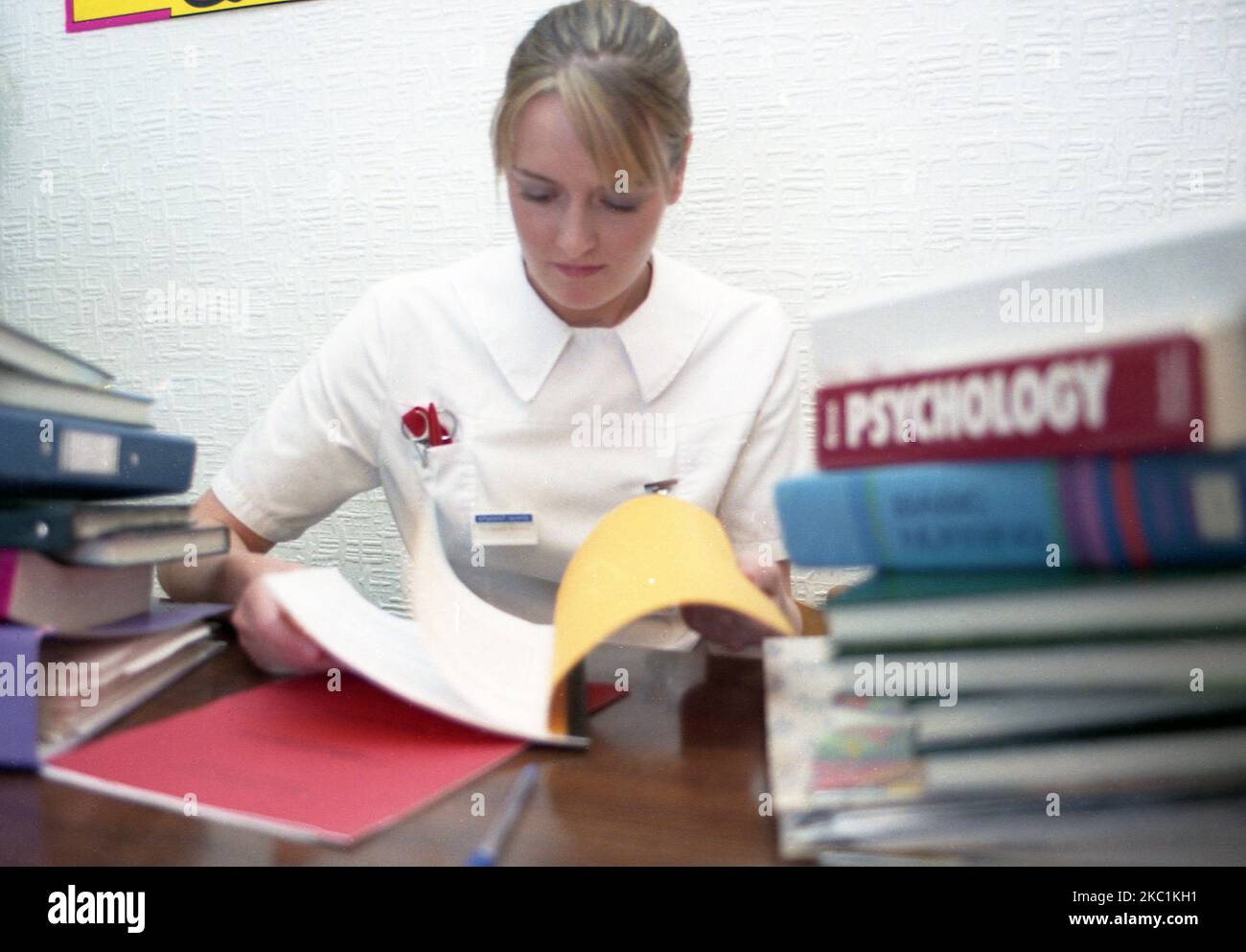 1990s, wearing a white nursing top, watch on chain and badge, a young ...