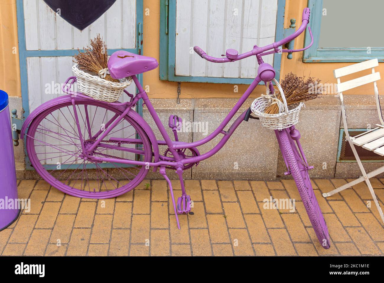 Purple Bicycle With Lavender Plants in Baskets Parked in Front of Shop ...