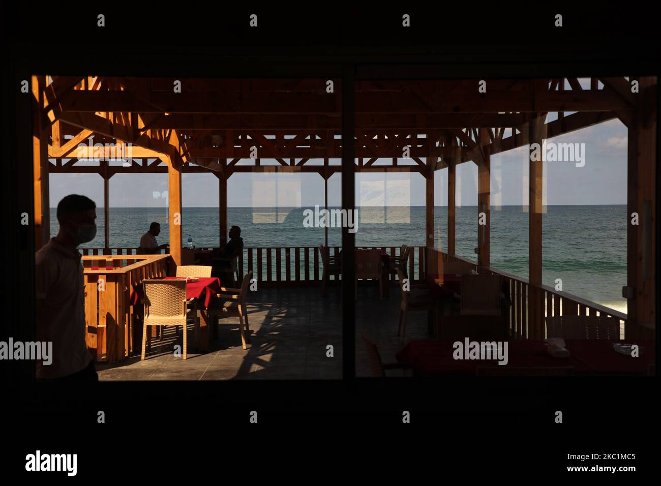 Men enjoy their time at a beach side cafe in Gaza City, Monday, Oct. 12 ...