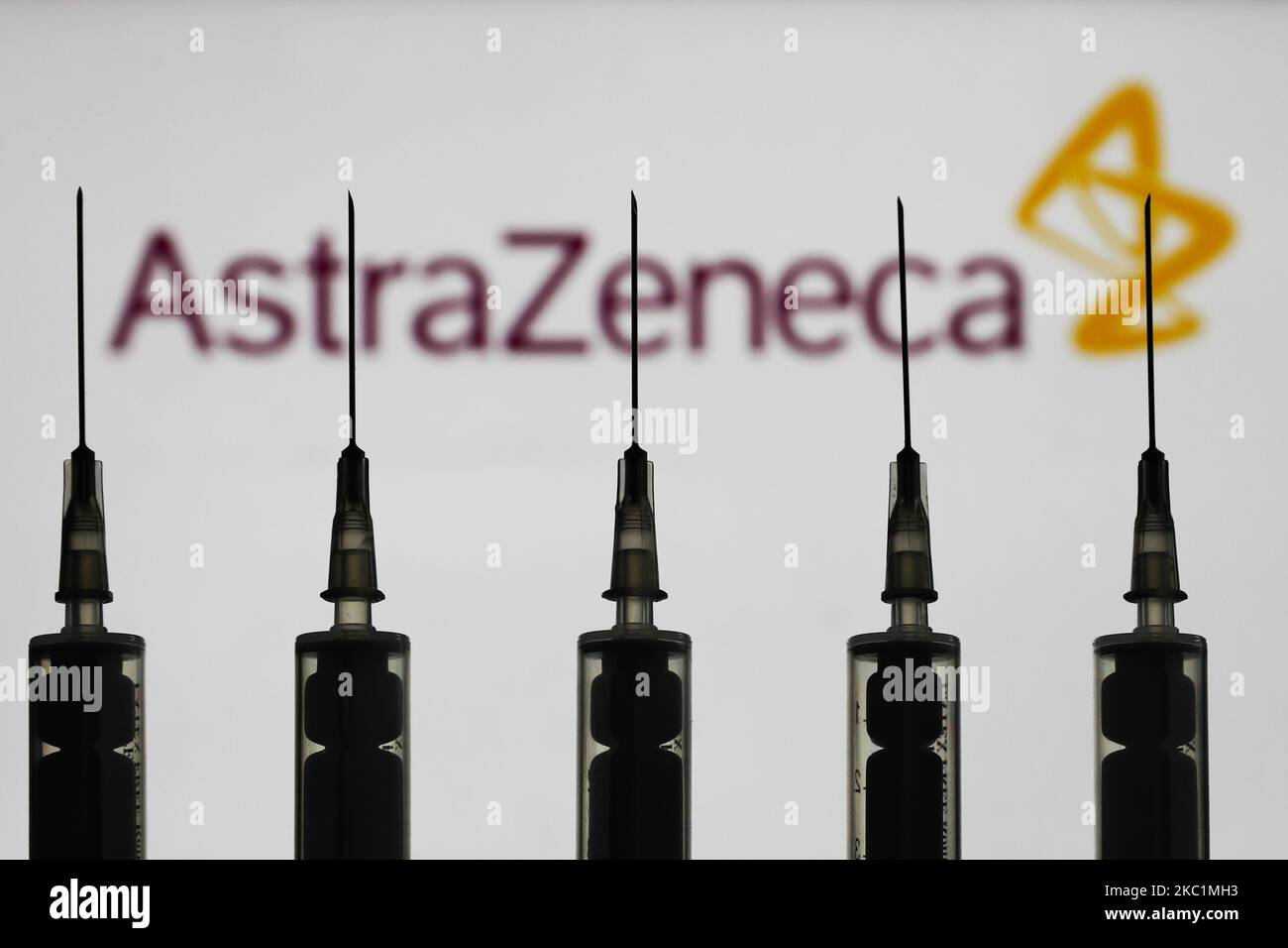 Medical syringes are seen with AstraZeneca company logo displayed on a ...