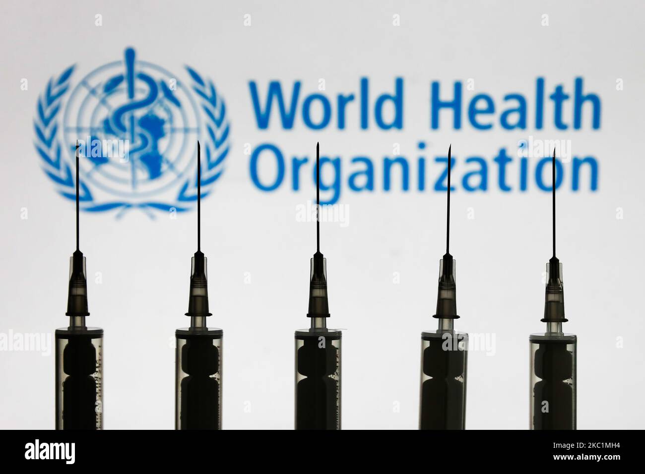 Medical syringes are seen with World Health Organization logo displayed ...