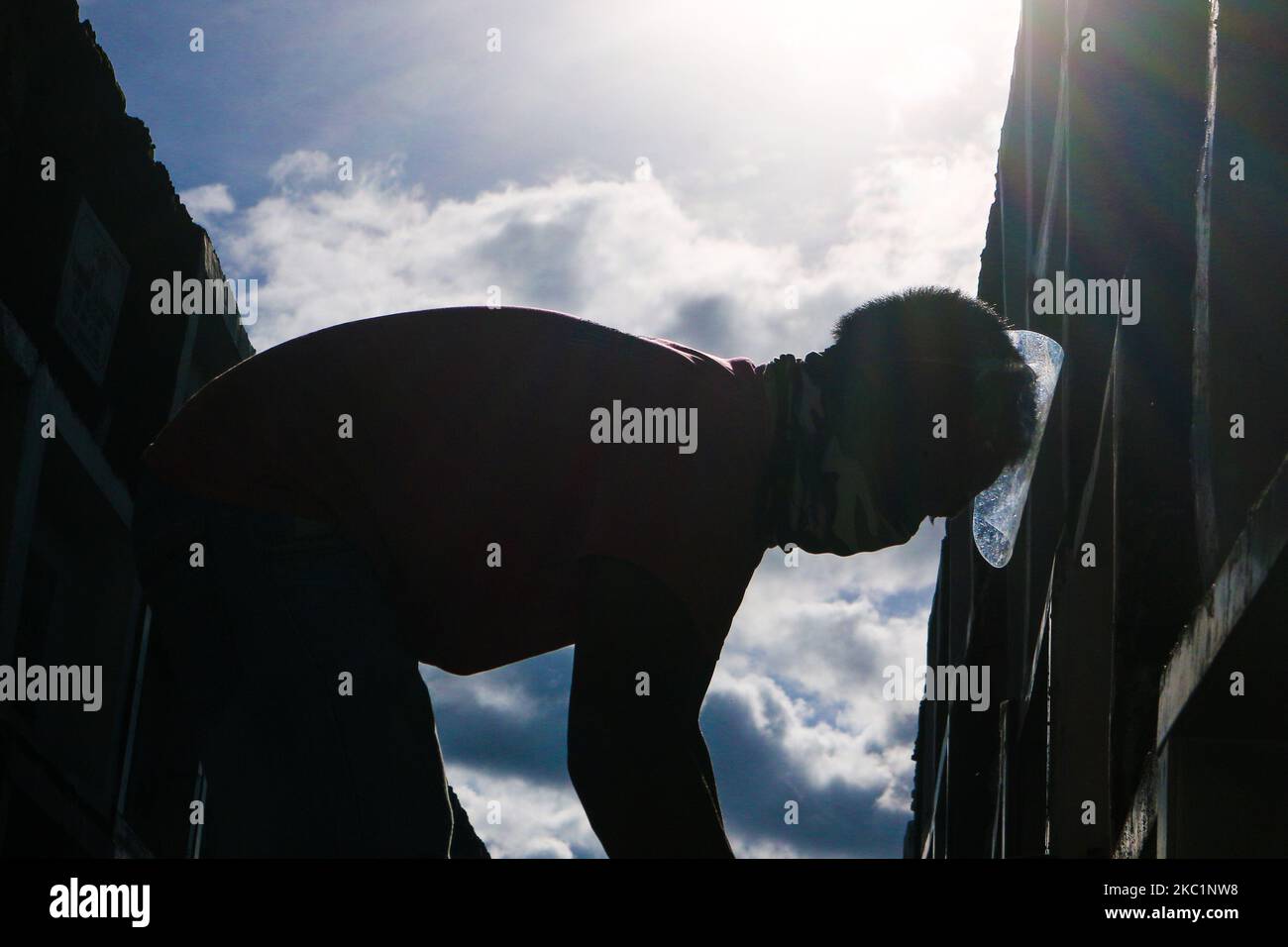 Erwin (in pink), working as exhumer and sepulture in public cemetery in ...