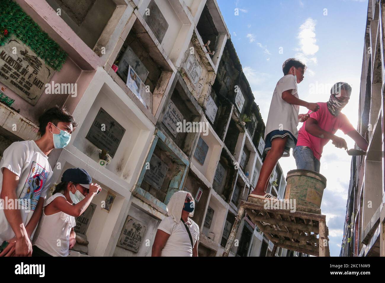 Erwin (in pink), working as exhumer and sepulture in public cemetery in ...