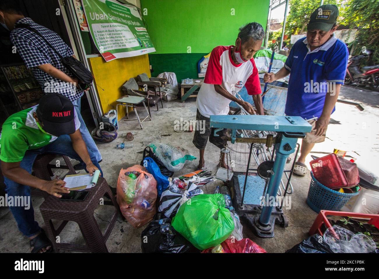 A man records on Bank Sampah saving book at the Bank Sampah Guyub Rukun ...