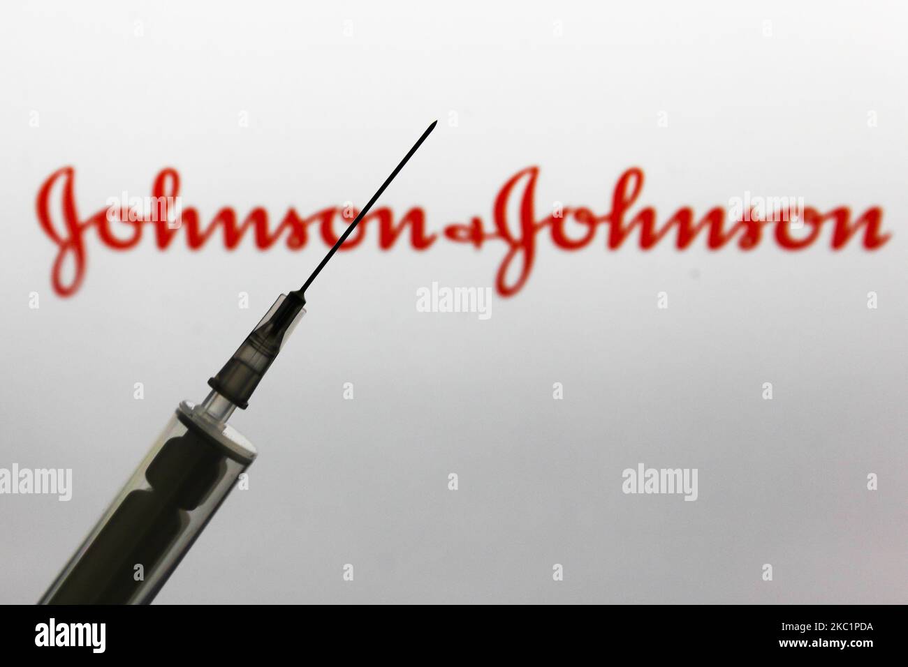 Medical syringe is seen with Johnson & Johnson company logo displayed ...