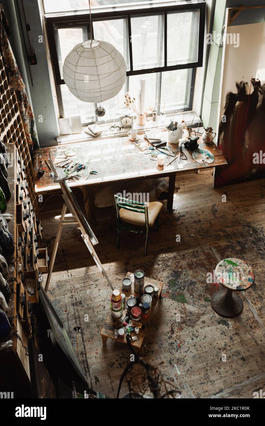 spacious workshop with large window and art tools on windowsill near ...