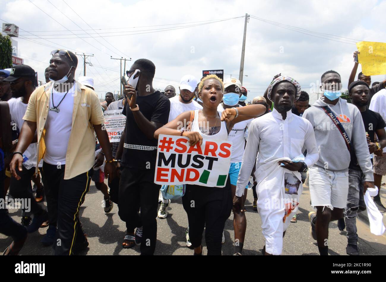 Youths of ENDSARS protesters display their placards in a crowd in ...
