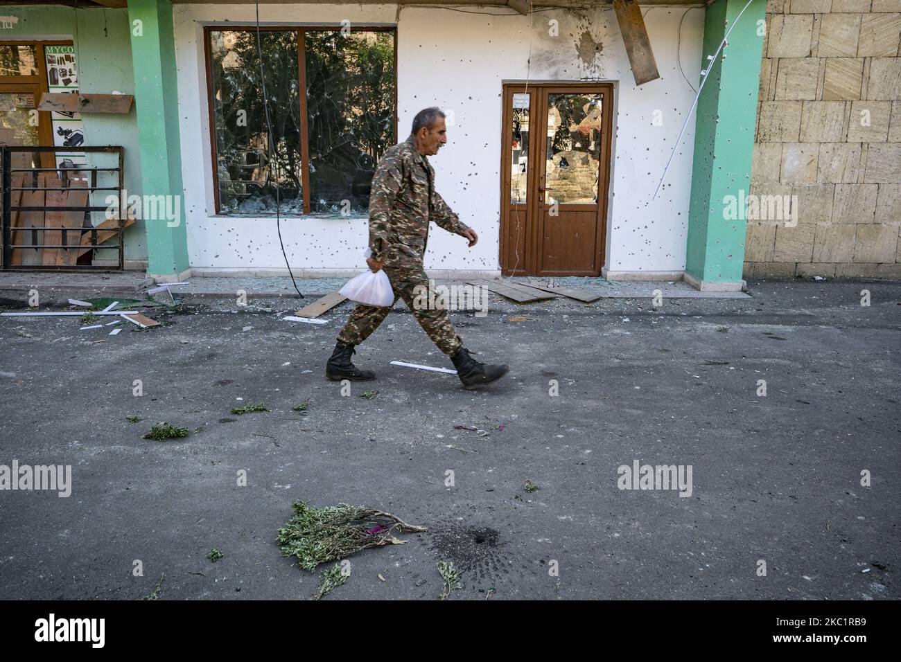 A soldier walks in a Stepanakert street shelled by cluster ammunition ...