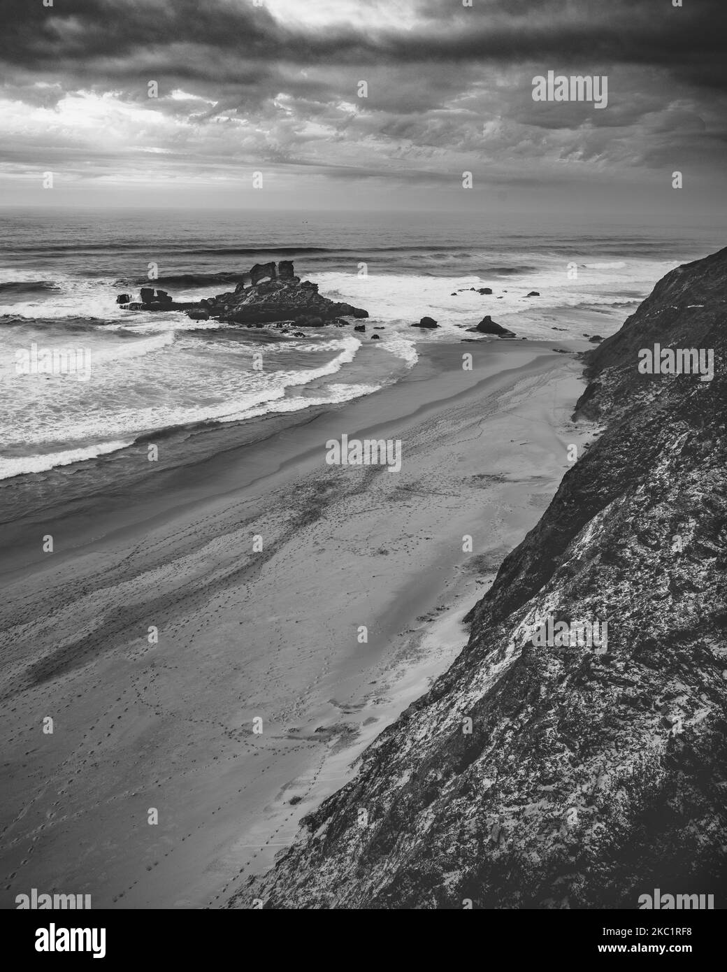 A vertical grayscale shot of the rock formations on the west coast of ...