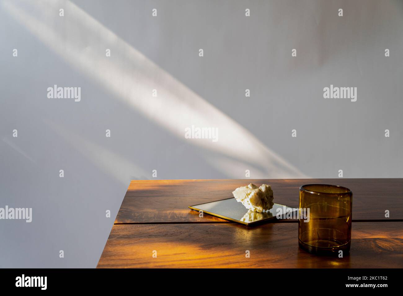 designer wood dining table, minimalist and simple objects on the table ...