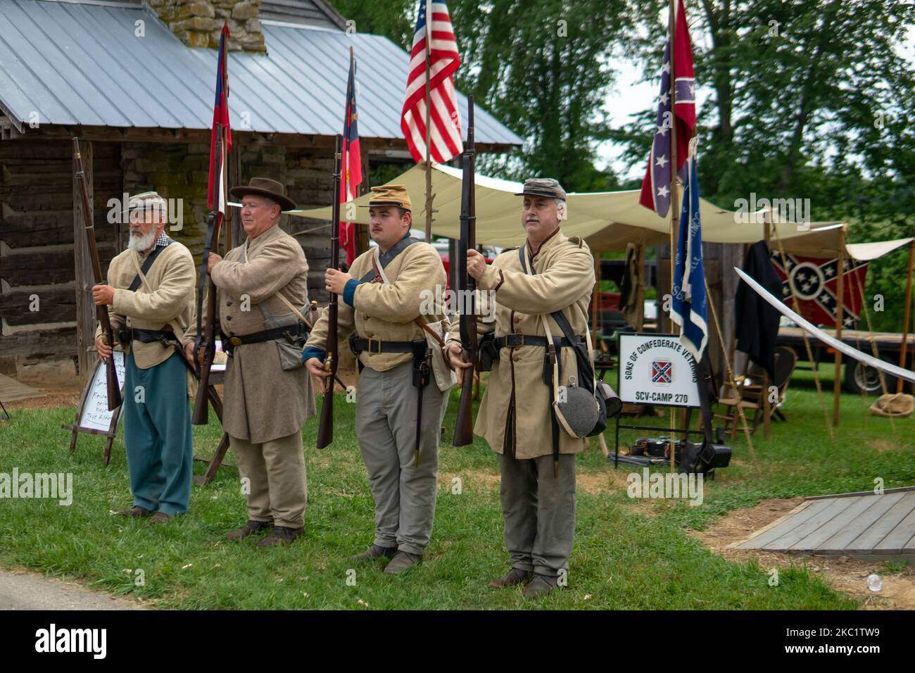 The middle-aged men in old military uniforms posing with guns. 52nd ...
