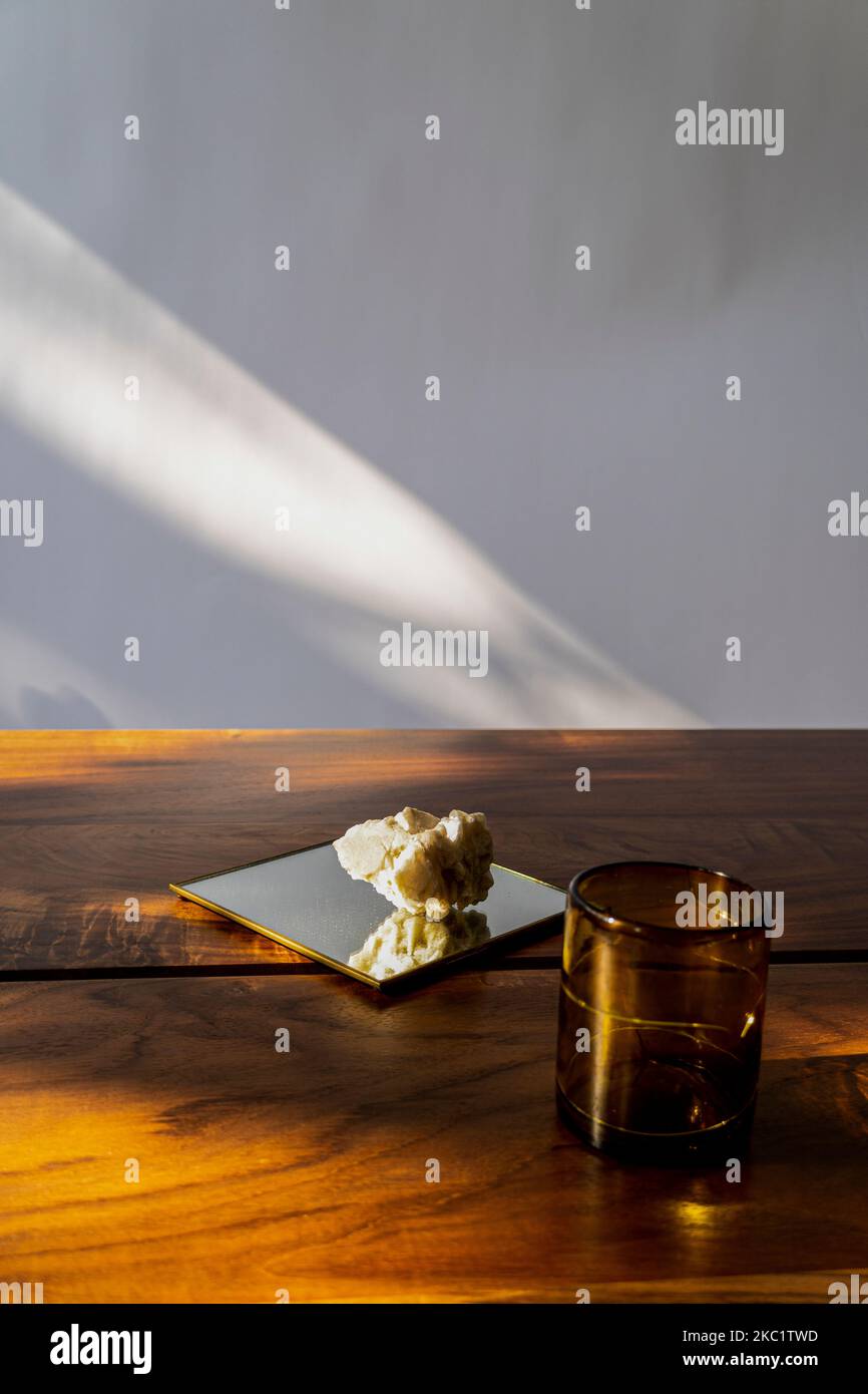 designer wood dining table, minimalist and simple objects on the table ...