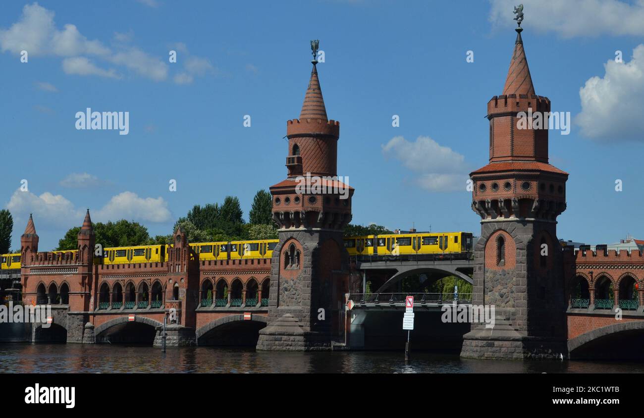 yellow Berlin subway is running aboveground over bridge "Oberbaumbrücke ...