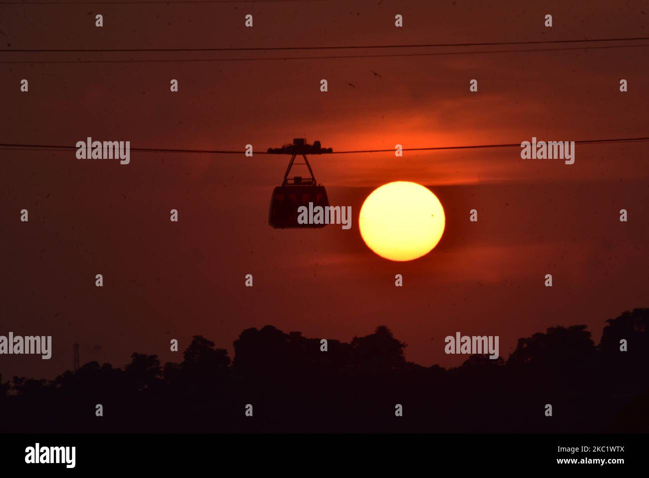 People travel over the River Brahmaputra in ropeway in Guwahati, India ...