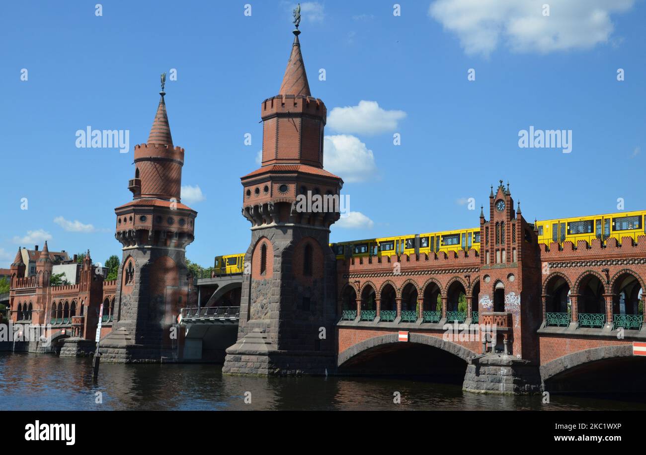 yellow Berlin subway is running aboveground over bridge "Oberbaumbrücke ...