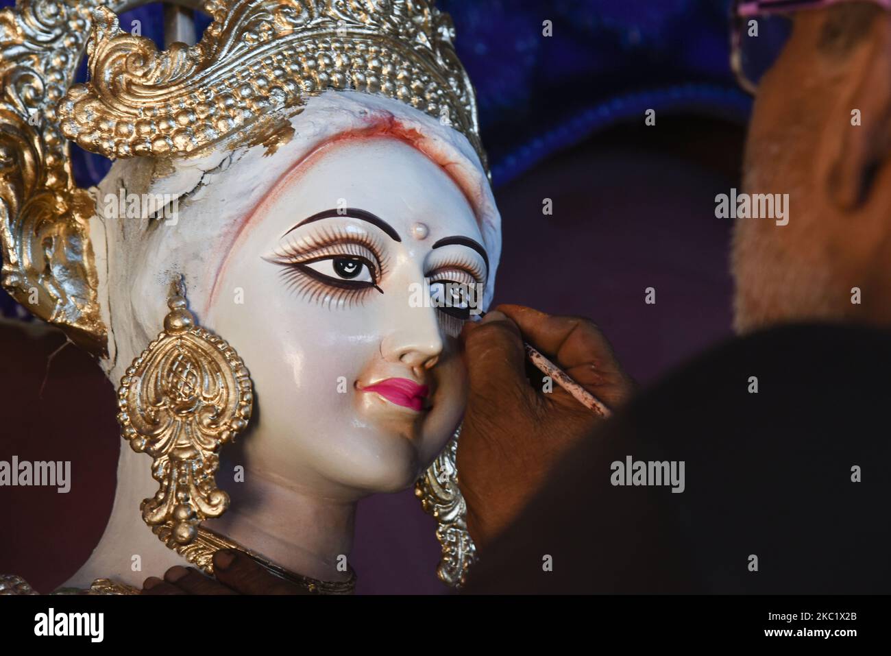 Artist drawing eyes on a Durga idol at a worshop ahead of Durga Puja ...