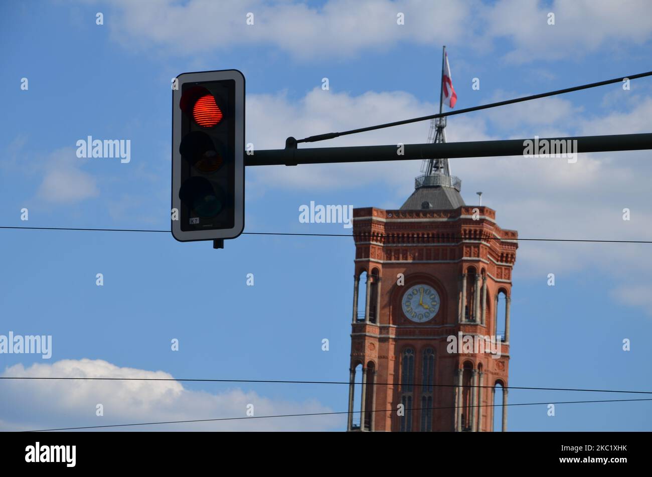 red traffic light in front of red townhall tower of "Rotes Rathaus" in ...