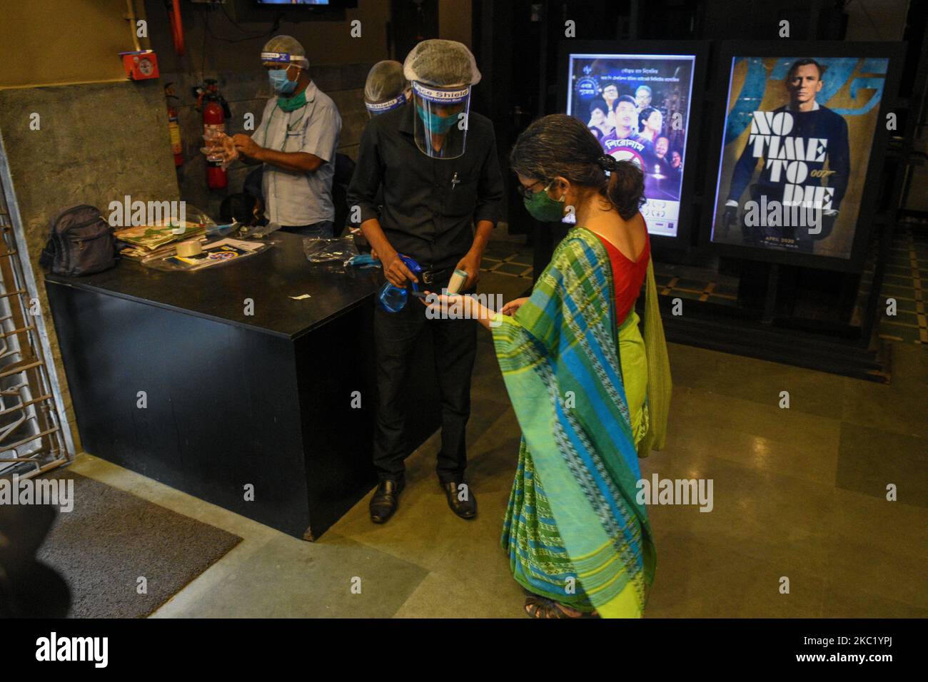 Thermal checking at entry point of a movie theater in Kolkata, India ...
