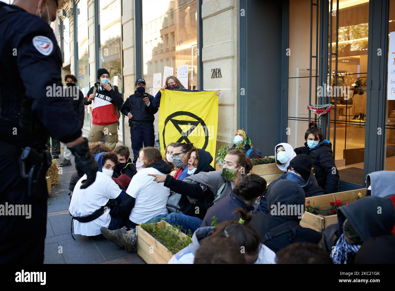 Activists are chained to the Zara shop doors. Members and activists ...