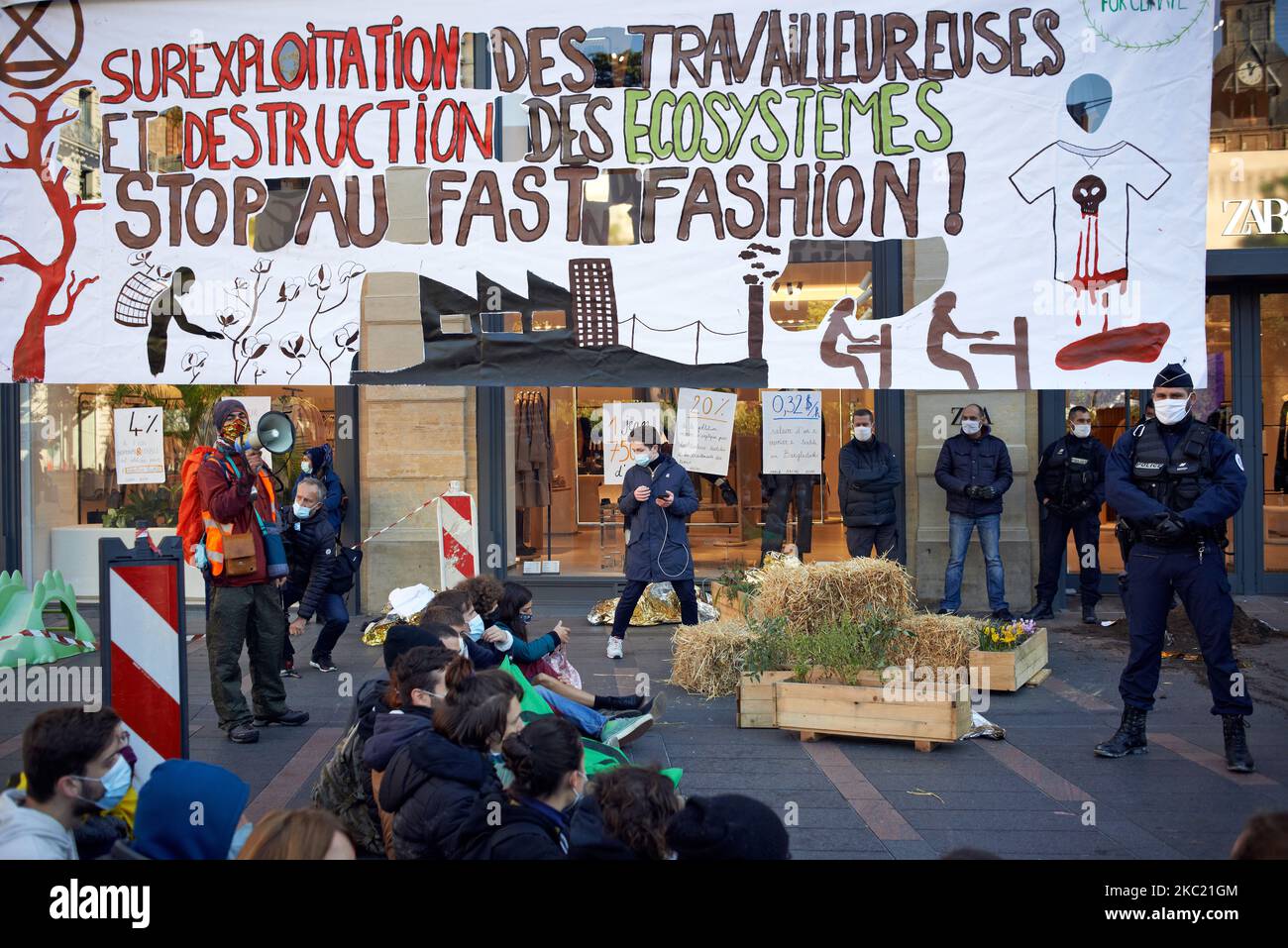 Policemen stand guard in front of the Zara shop. the banne reads ...
