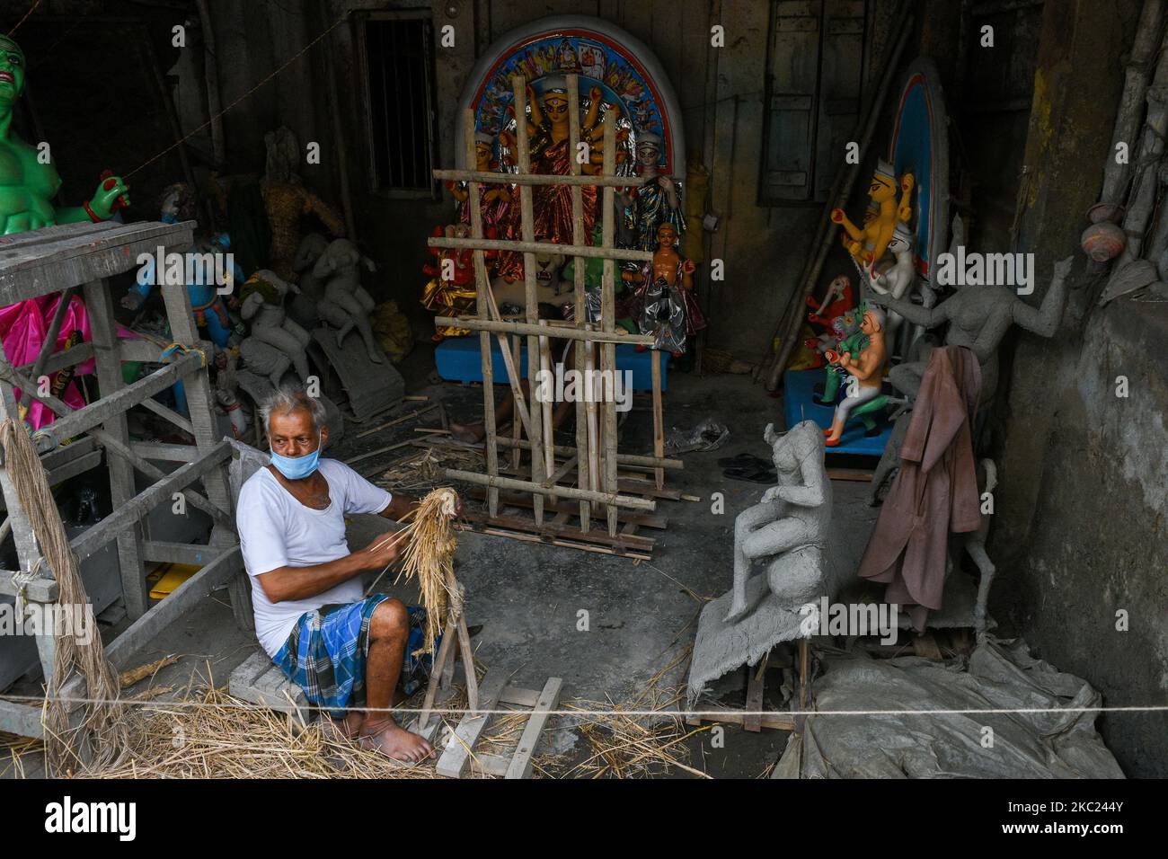 A worker making an idol of Durga at a potters hub of kumartuli.The city ...