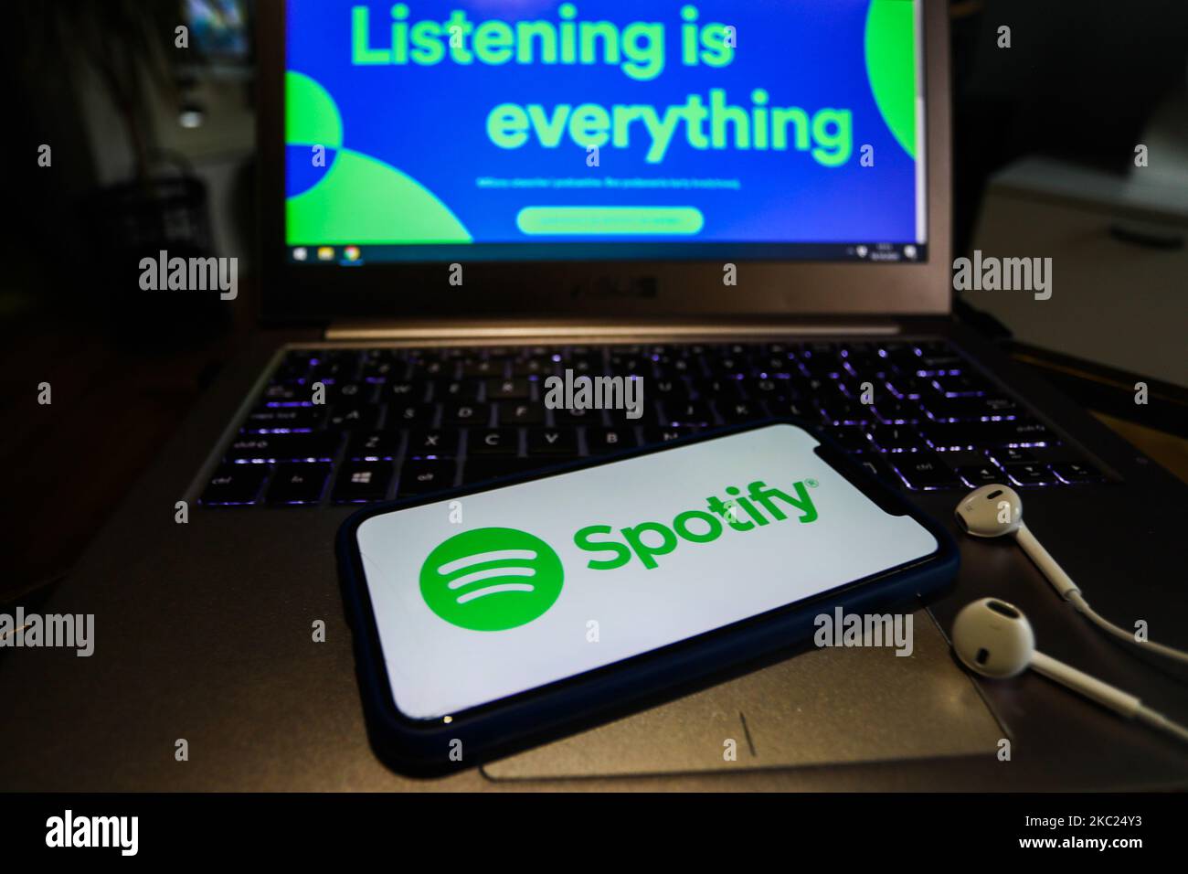 Spotify logo displayed on a phone screen and Spotify website displayed ...