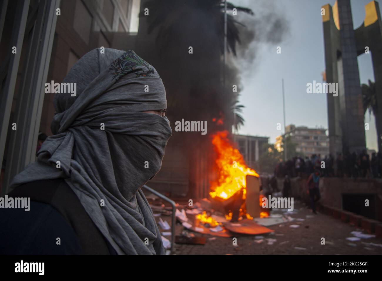 A hooded protester and a barricade located in carabineros de Chile ...