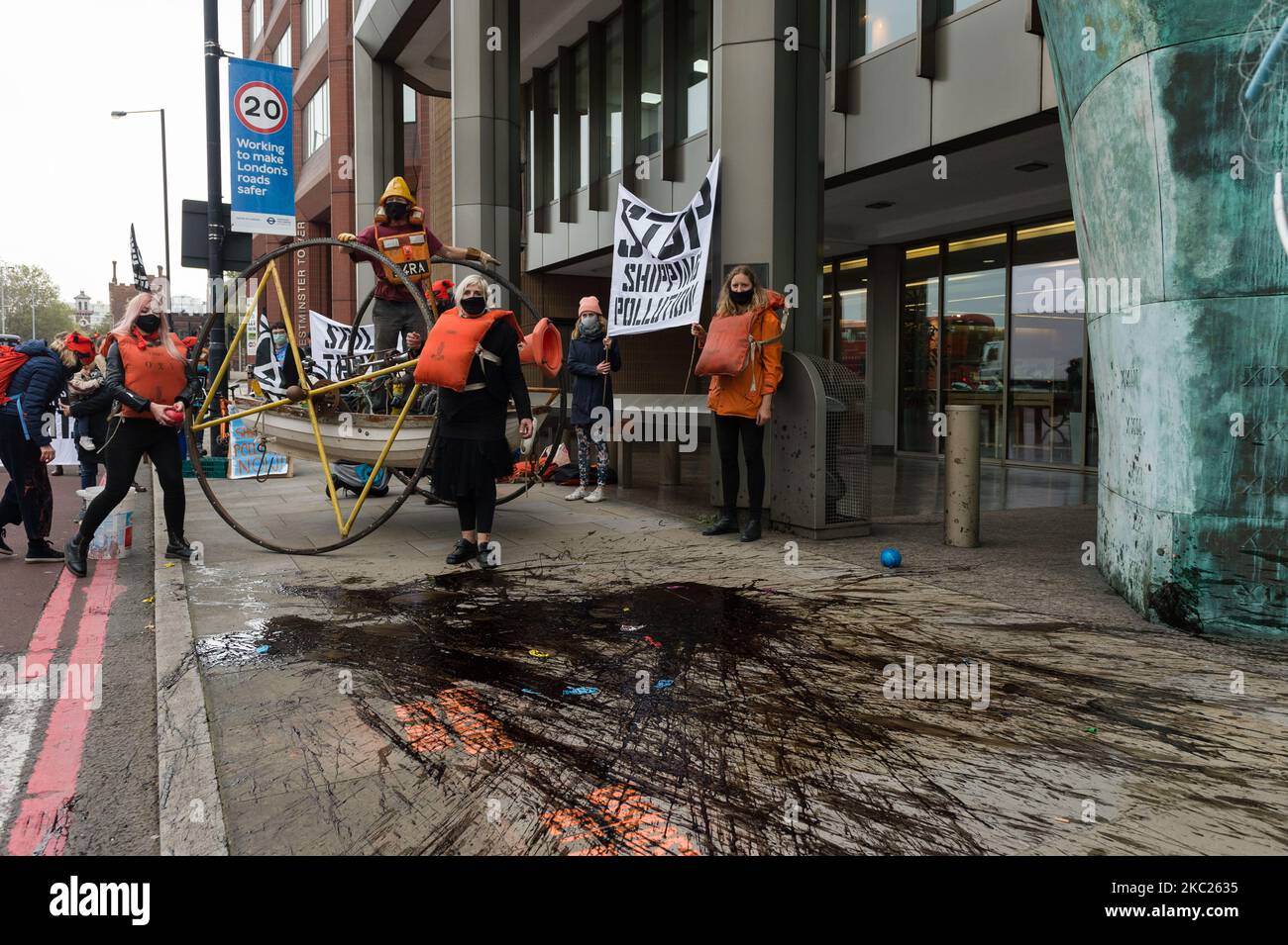 Activists from The Ocean Rebellion spill the fake oil during a protest ...