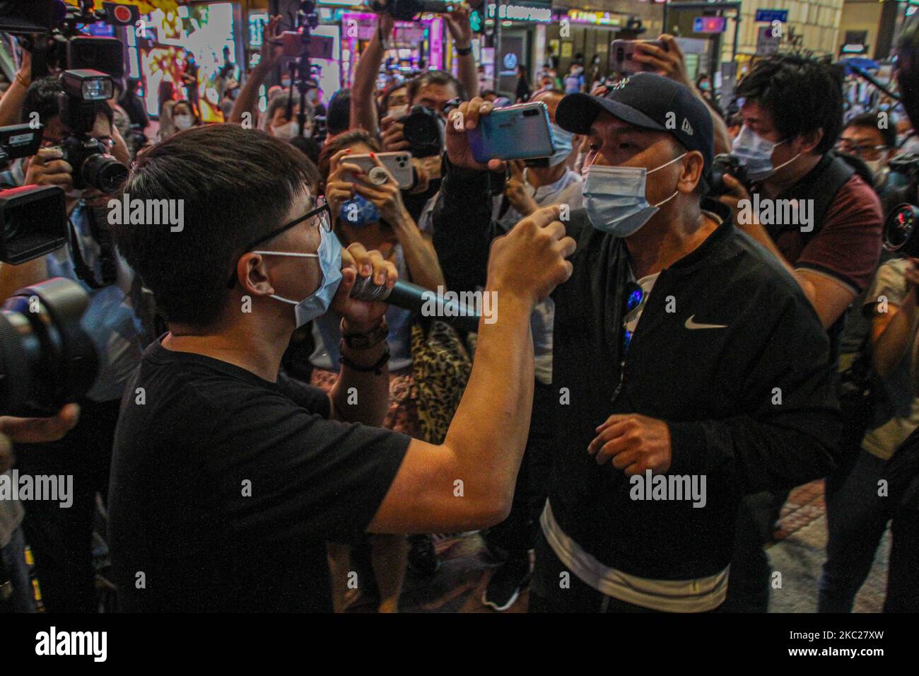 Hong Kong activist Joshua Wong argues a pro-Beijing supporter who ...