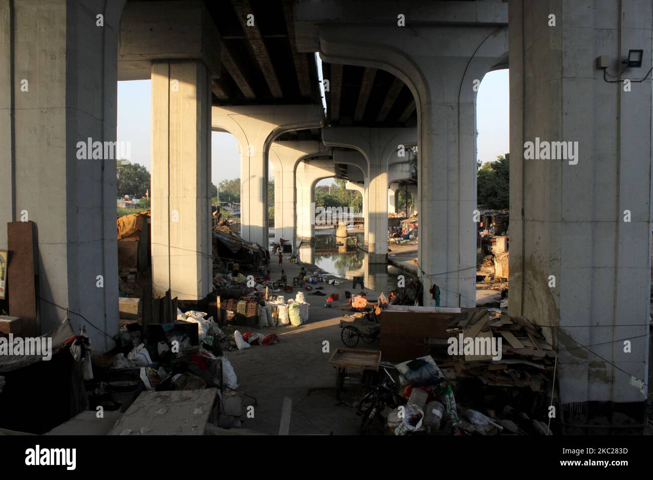 A view of a slum dwelling cluster along a drain under Baba Banda Singh ...