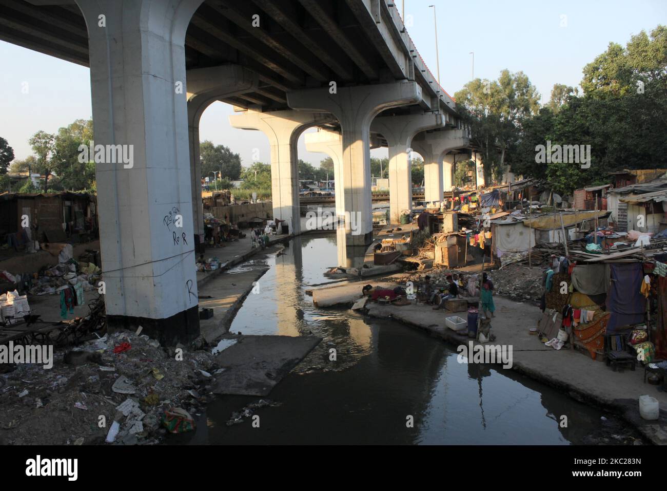 A view of a slum dwelling cluster along a drain under Baba Banda Singh ...
