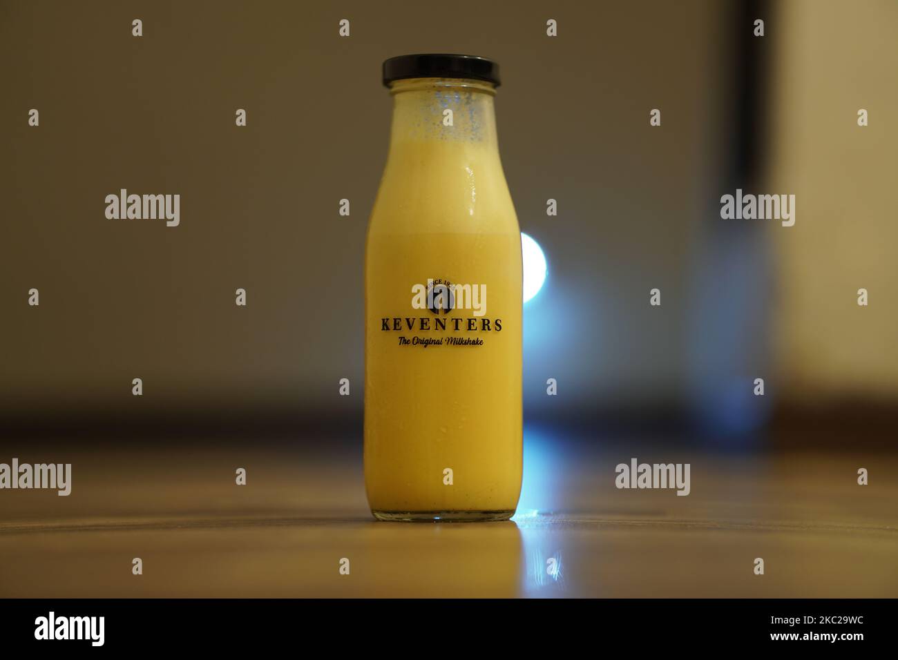 A closeup shot of keventers milk shake with mango flavor on a wooden ...