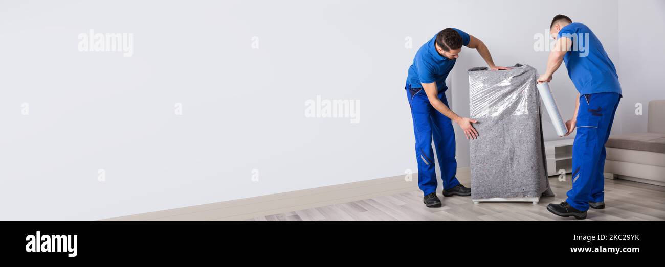 Professional Furniture Movers Wrapping. House Packing Service Stock ...