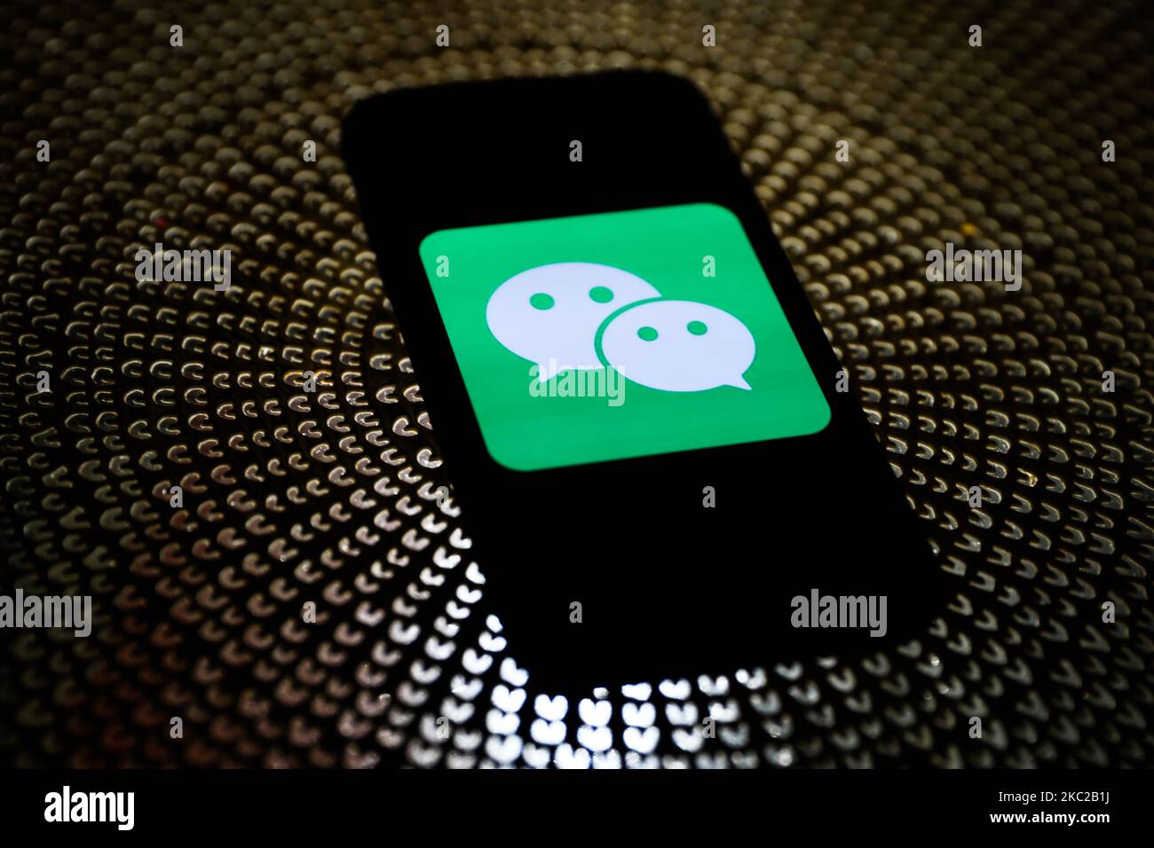 WeChat logo displayed on a phone screen is seen in this illustration ...