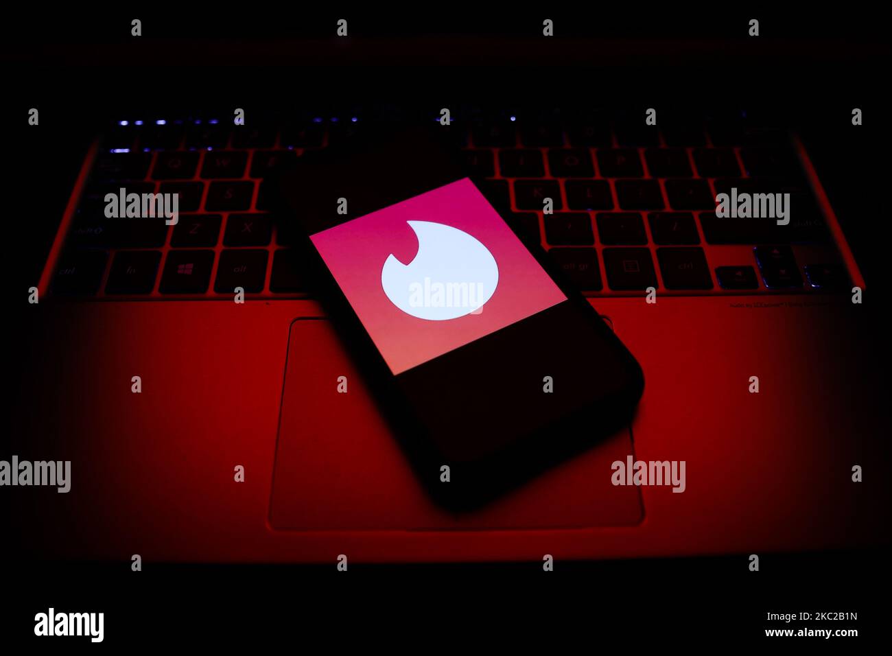 Tinder logo displayed on a phone screen is seen in this illustration ...