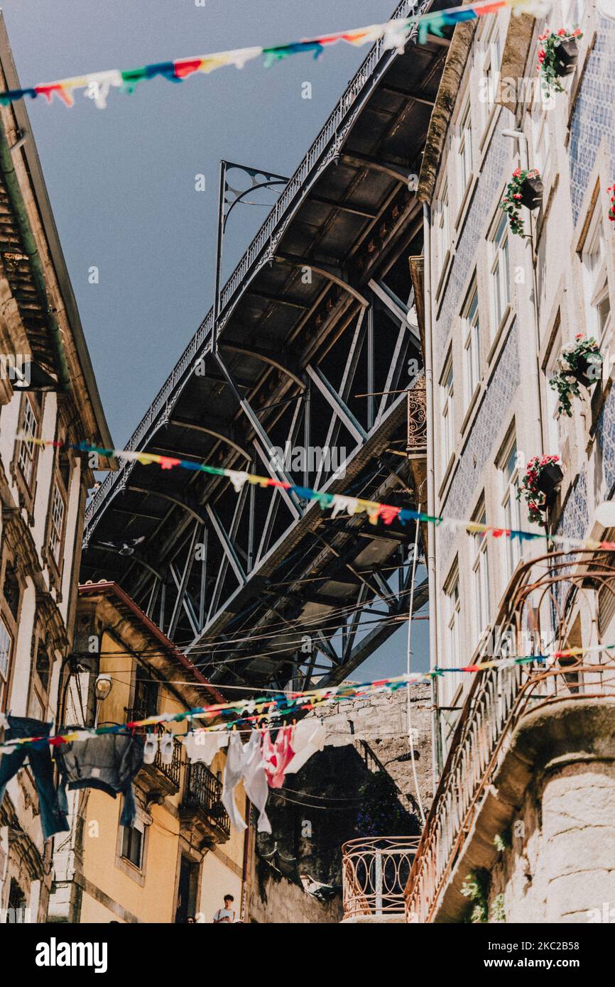 A view under the Porto bridge with flags and drying clothes over the ...